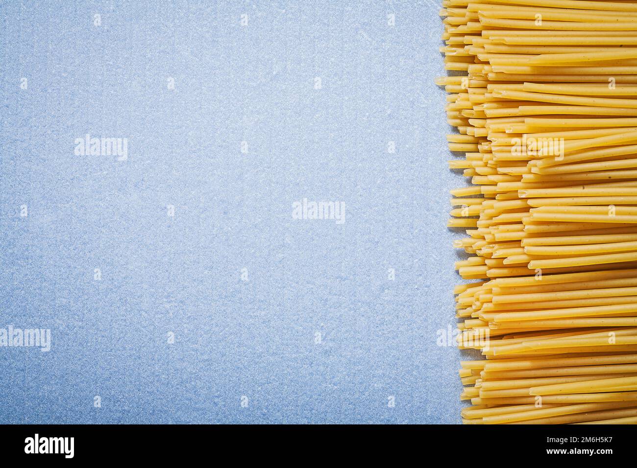 Italian spaghetti on blue background copy space food and drink concept ...