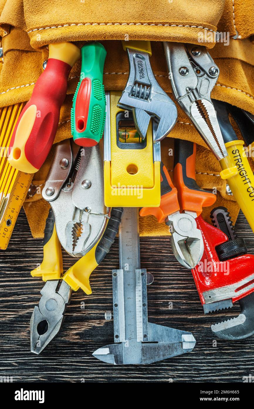 Leather tool belt construction tooling on wooden background Stock Photo ...