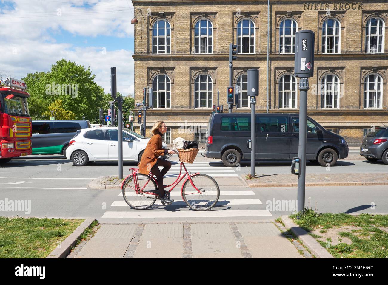 Cyclists ride through a traffic road junction in Copenhagen, Denmark ...