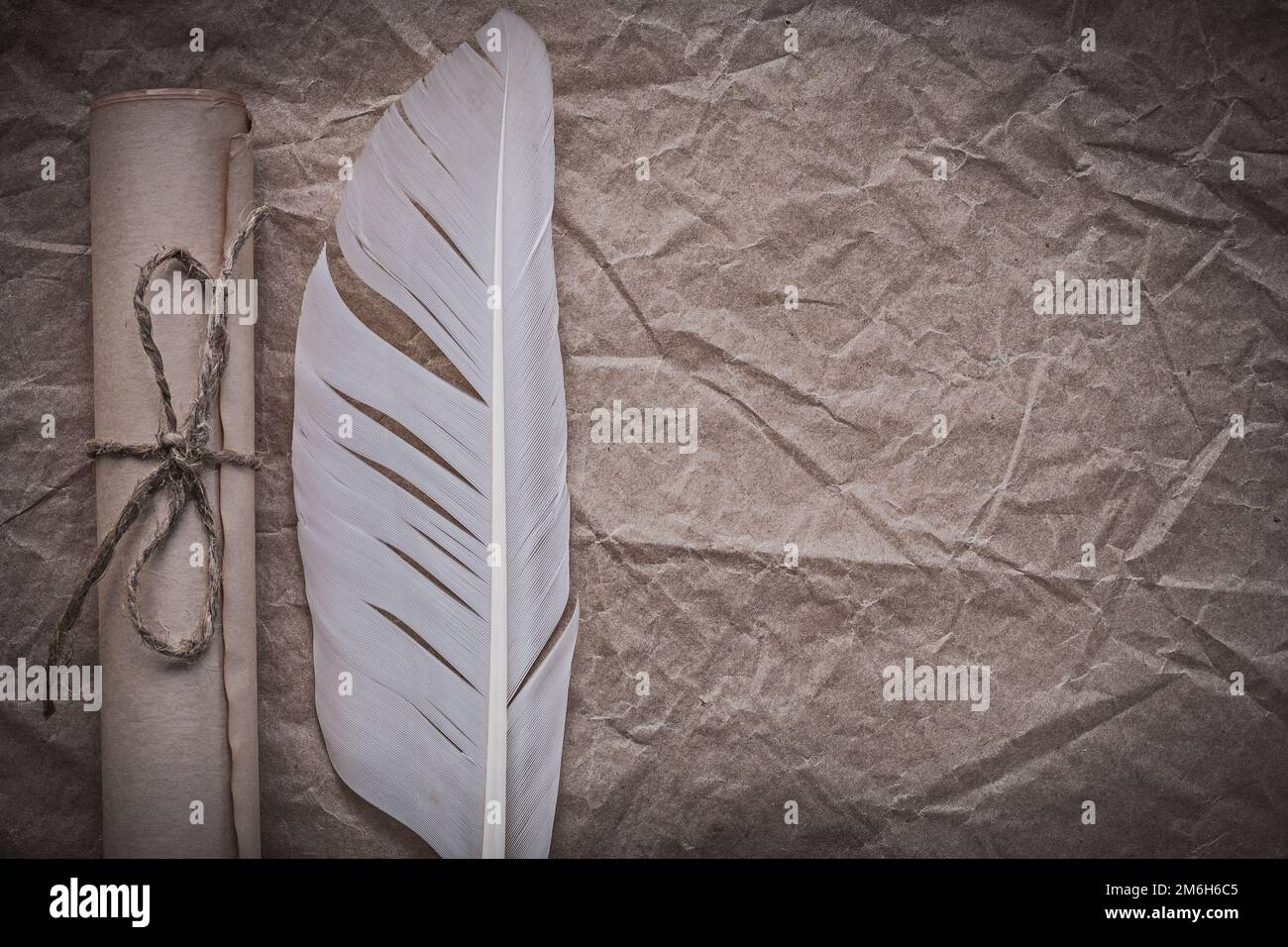 Medieval paper scroll plume on crumpled wrapping sheet Stock Photo - Alamy