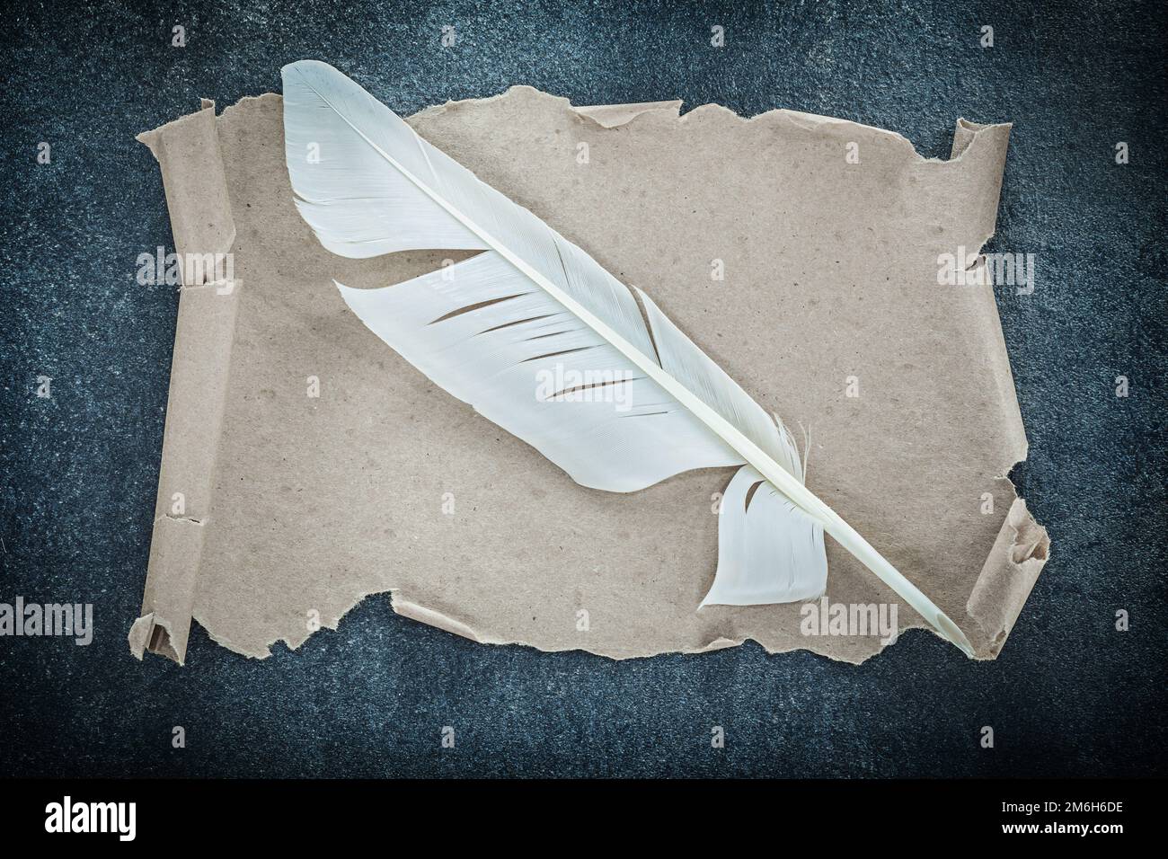 Medieval paper scroll quill on black background Stock Photo - Alamy