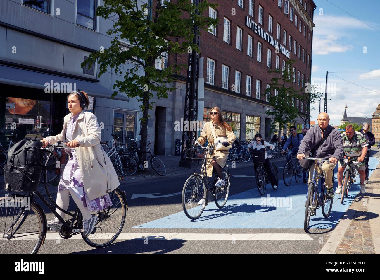 Cyclists ride through a traffic road junction in Copenhagen, Denmark ...
