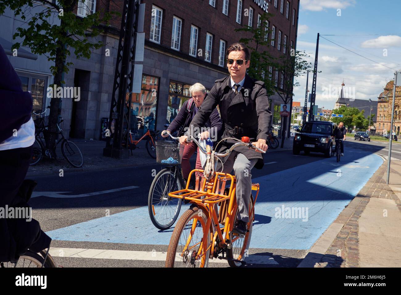 Cyclists ride through a traffic road junction in Copenhagen, Denmark ...