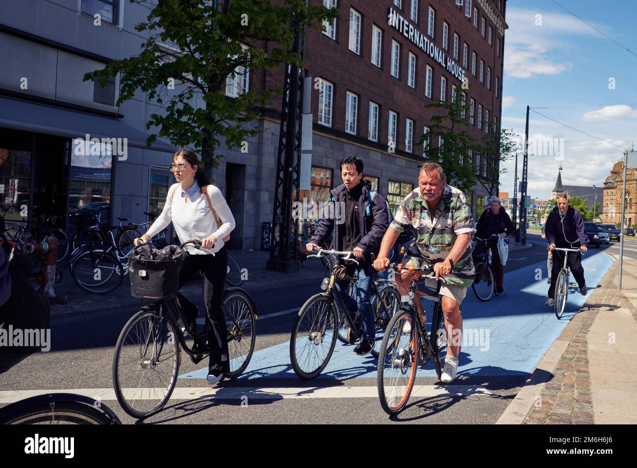 Cyclists ride through a traffic road junction in Copenhagen, Denmark ...