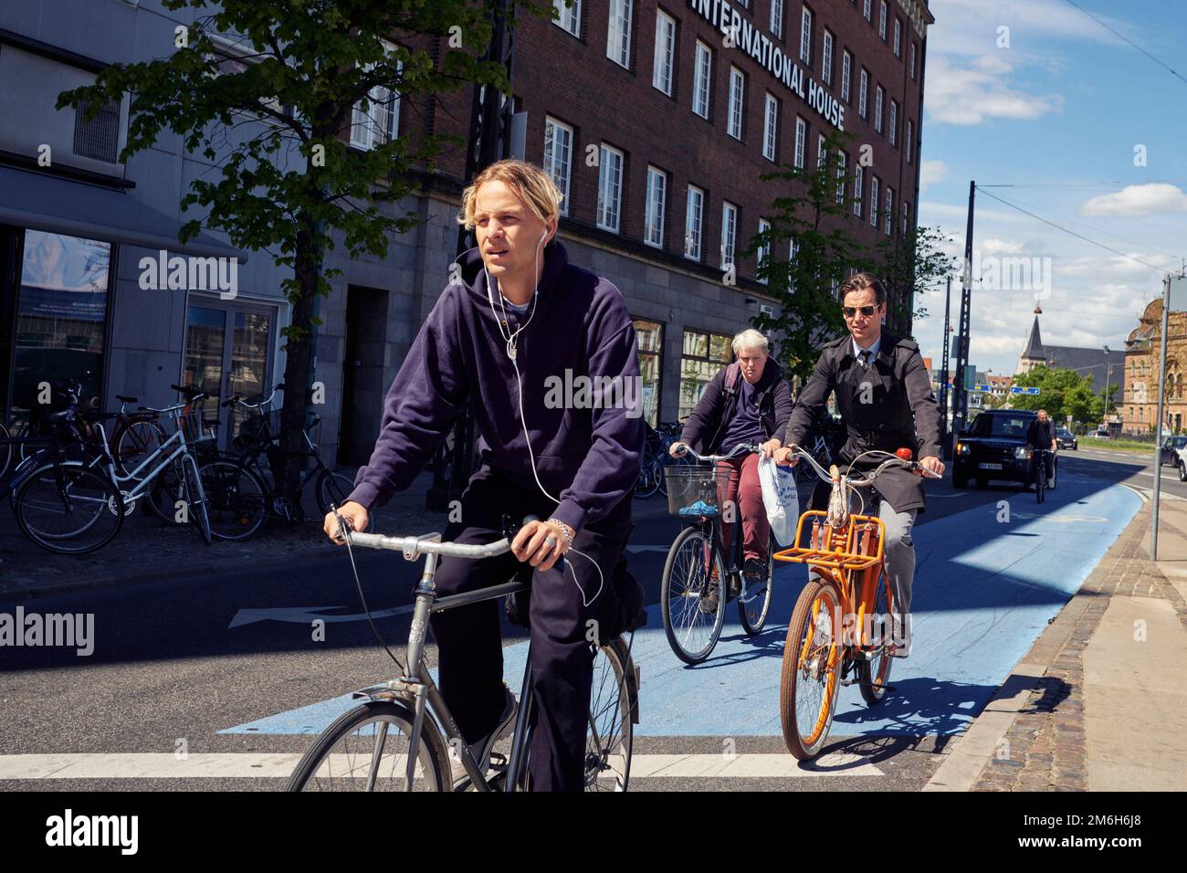 Cyclists ride through a traffic road junction in Copenhagen, Denmark ...