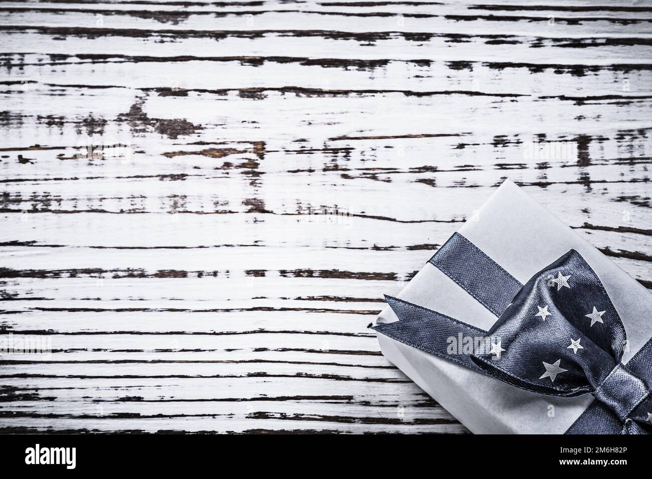 Present blue bow on vintage wooden board holidays concept Stock Photo ...