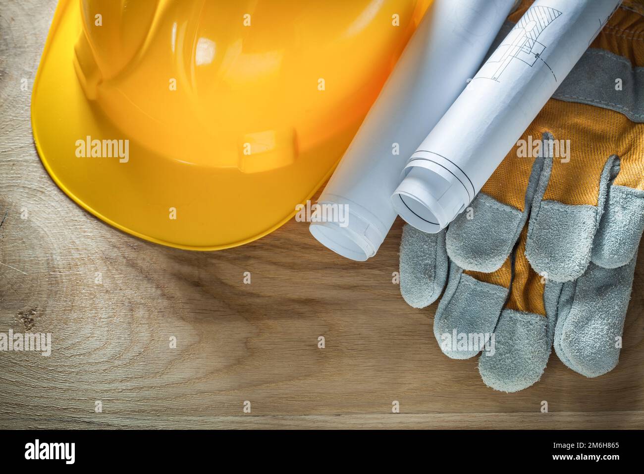 Protective gloves building helmet construction plans Stock Photo - Alamy