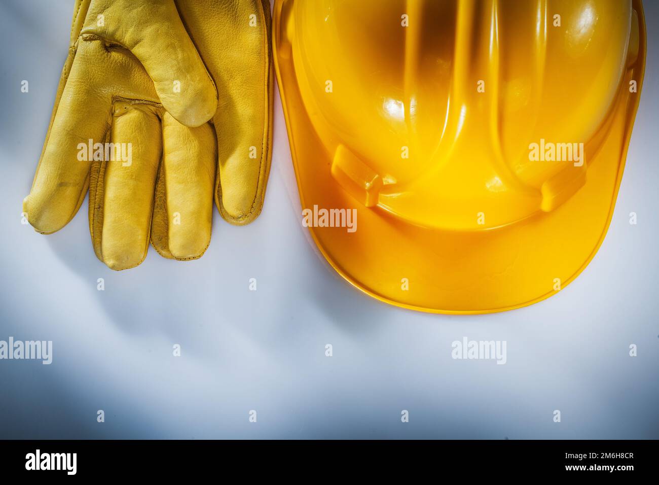 Protective gloves hard hat on white background Stock Photo - Alamy