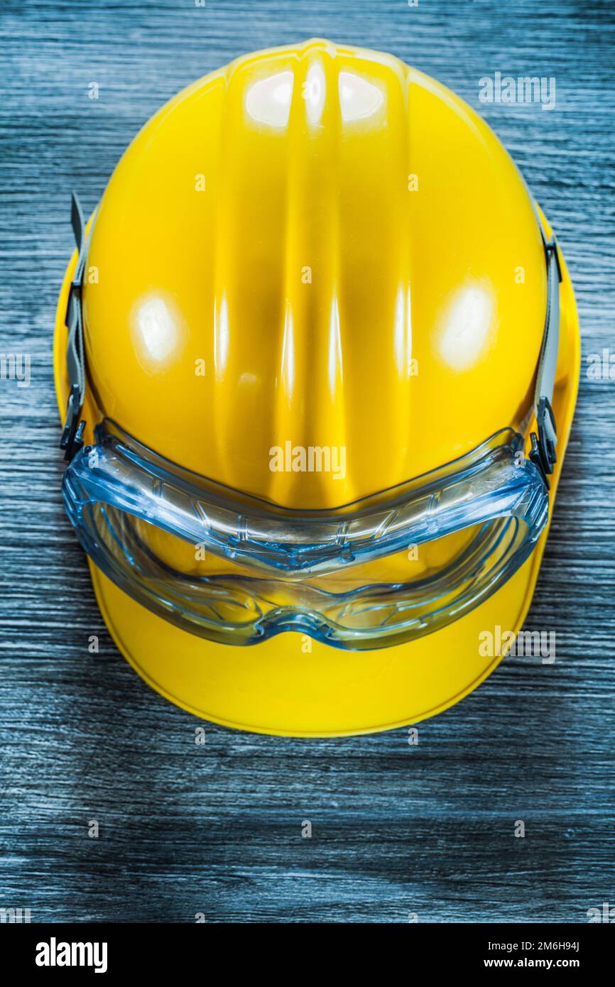 Safety building helmet goggles on vintage wooden board Stock Photo - Alamy