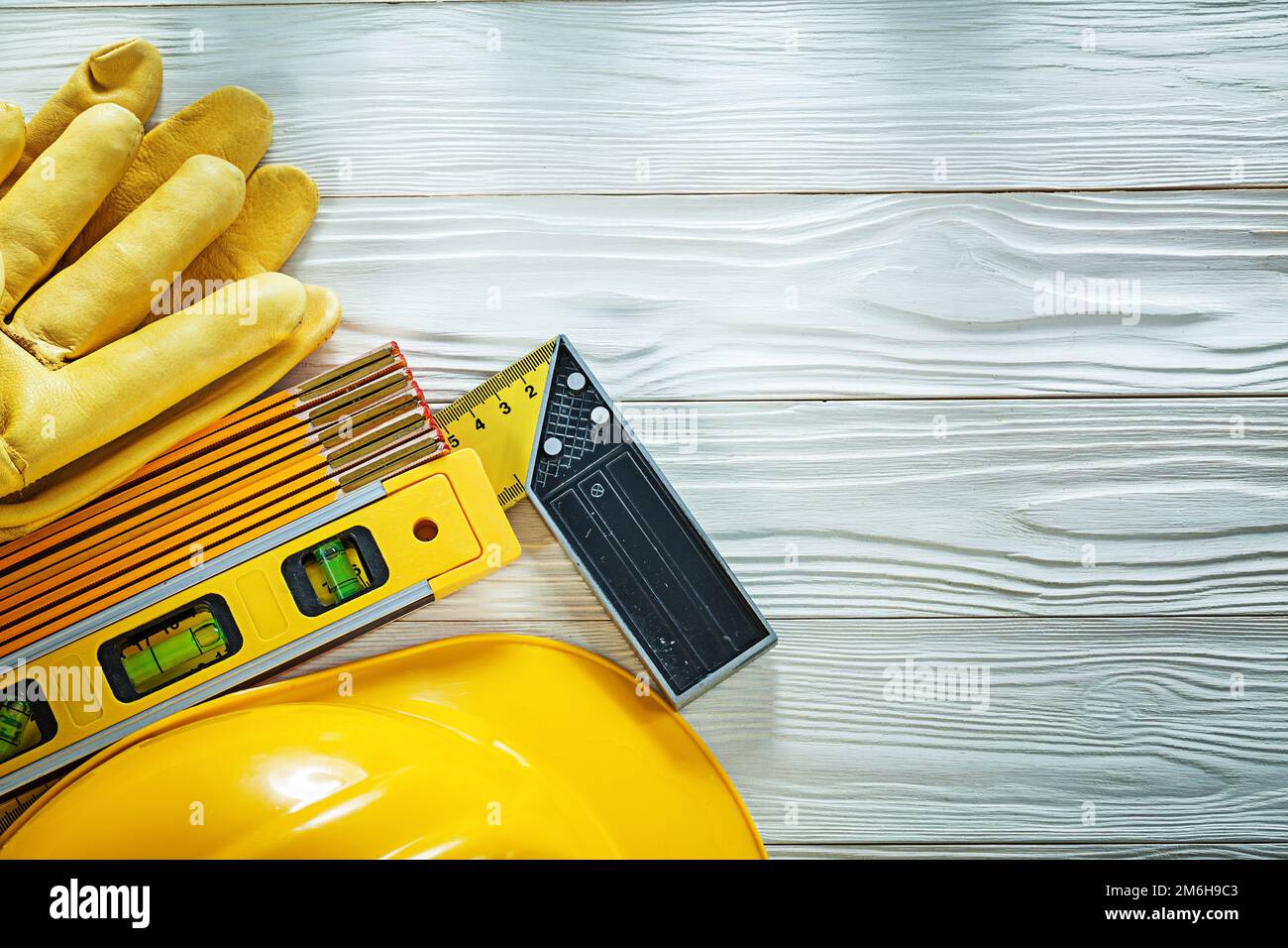 Safety gloves try square construction level wooden meter hard hat on ...