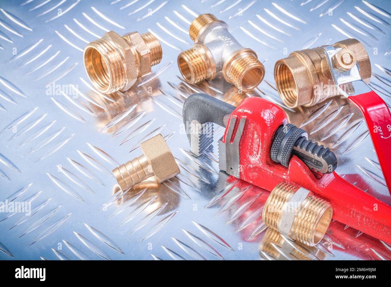 Set of brass hardware on channeled metal plate plumbing concept Stock ...