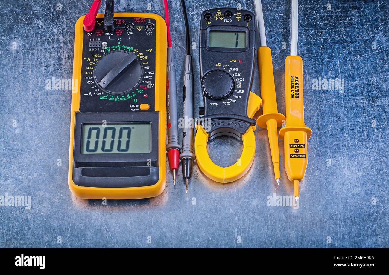 Set of digital clamp meter electric tester multimeter on metallic ...