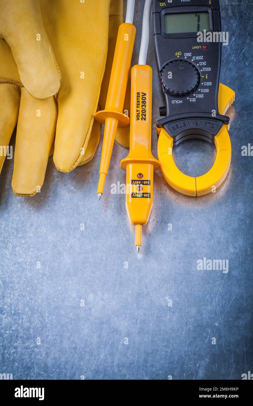 Set of digital clamp meter electrical tester protective gloves on ...