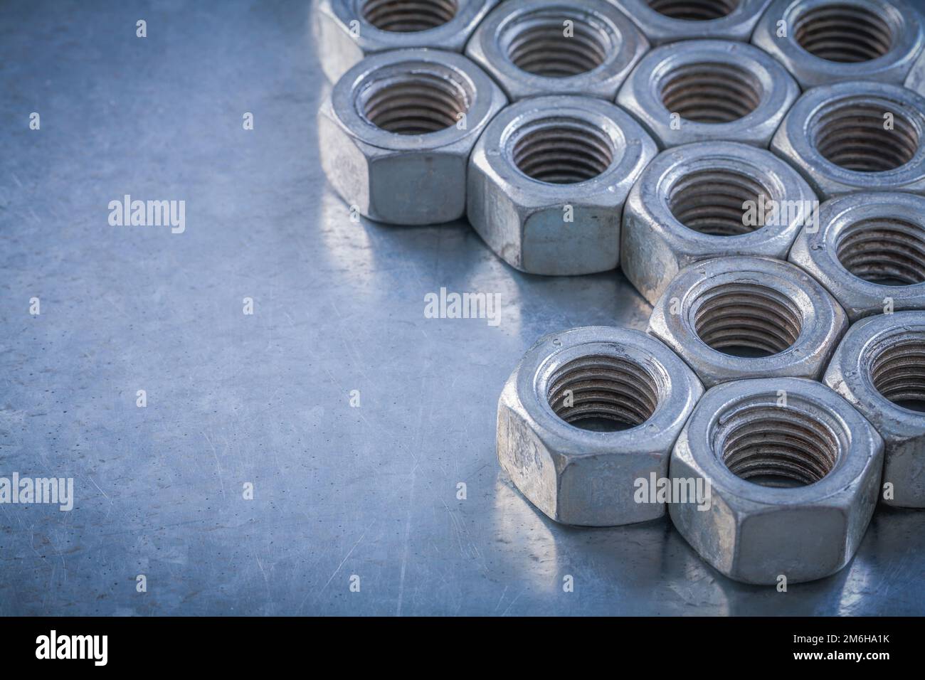 Stack of screw-nuts on metallic background maintenance concept Stock ...