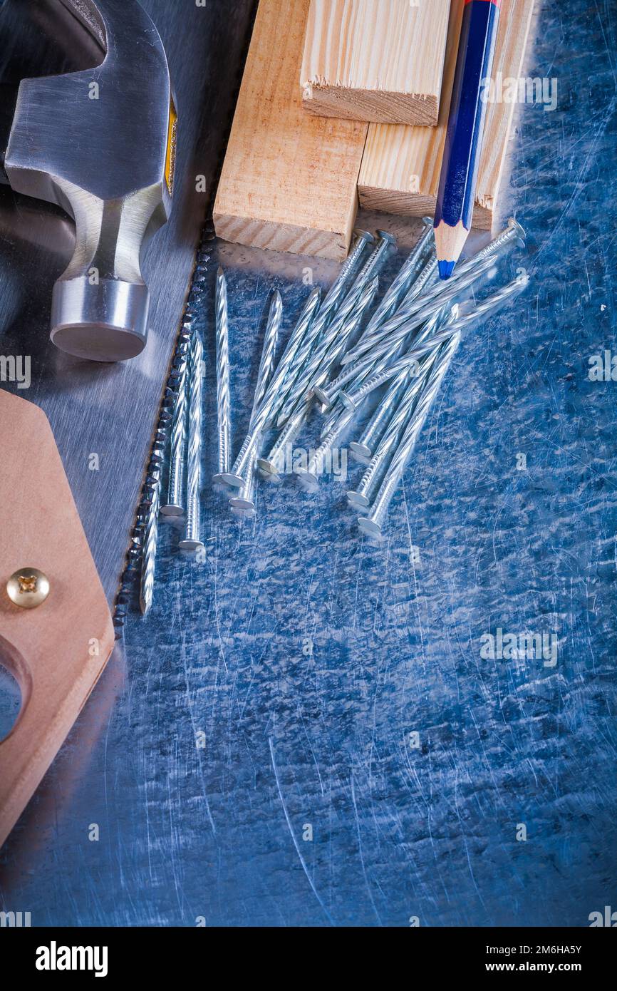 Steel nails hammer wooden studs hacksaw pencil on scratched vintage ...