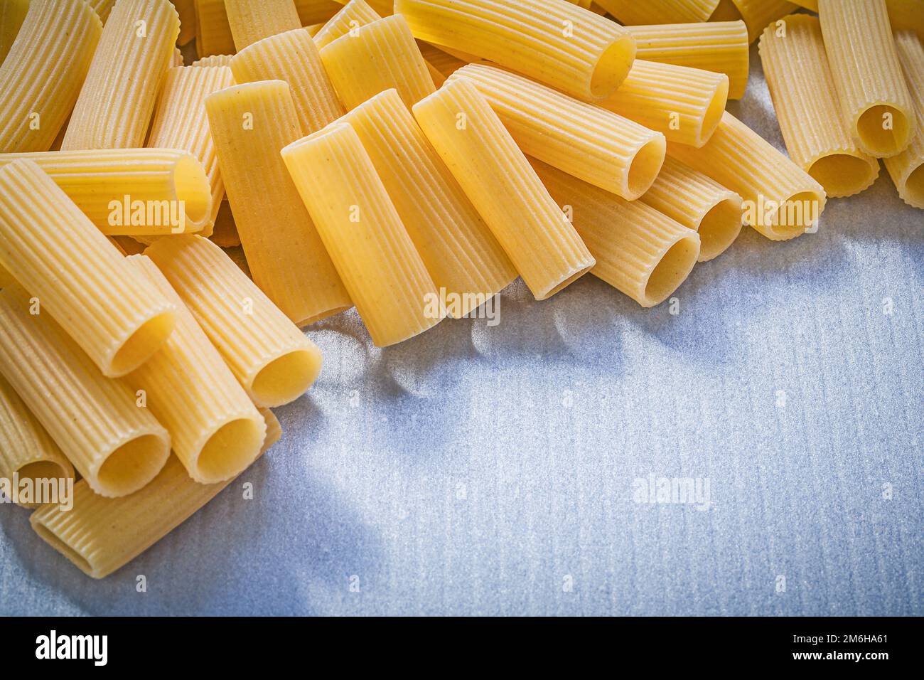 Stack of uncooked pasta on blue background food and drink concept Stock ...