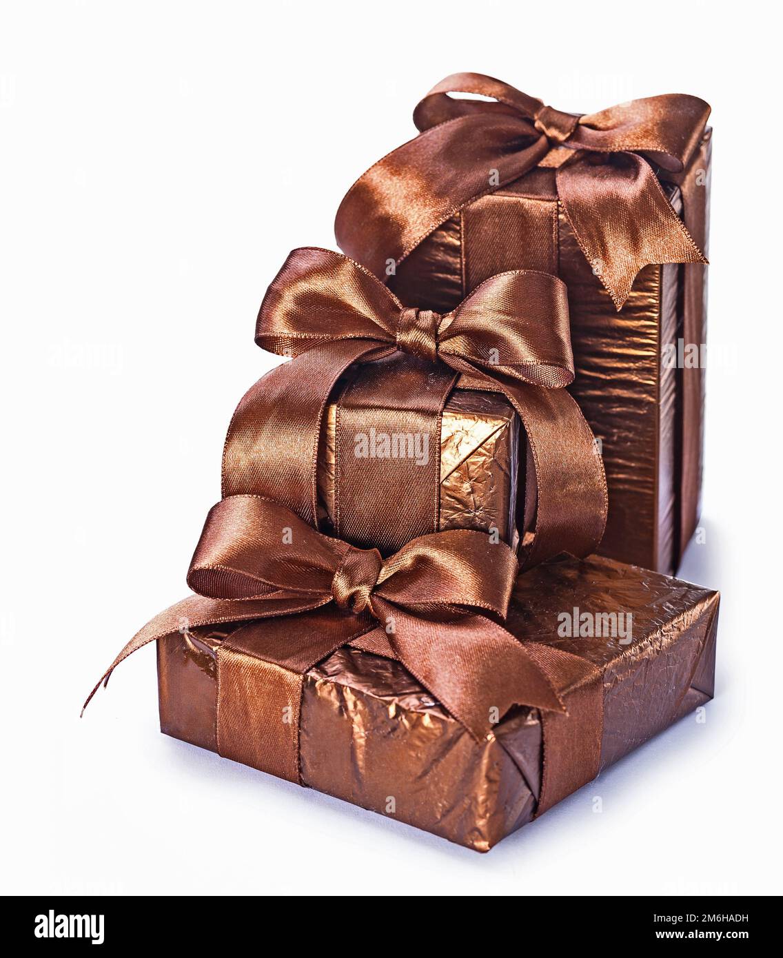 three brown gift boxes isolated on white background Stock Photo - Alamy
