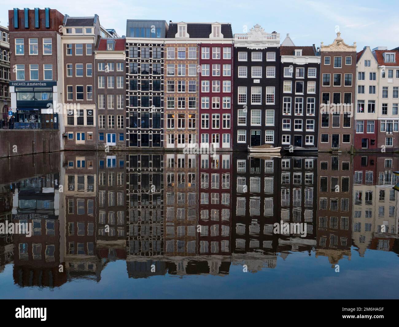 Row of typical houses with reflection in Damrak, Canal Water, Amsterdam, Noord-Holland, Holland ...