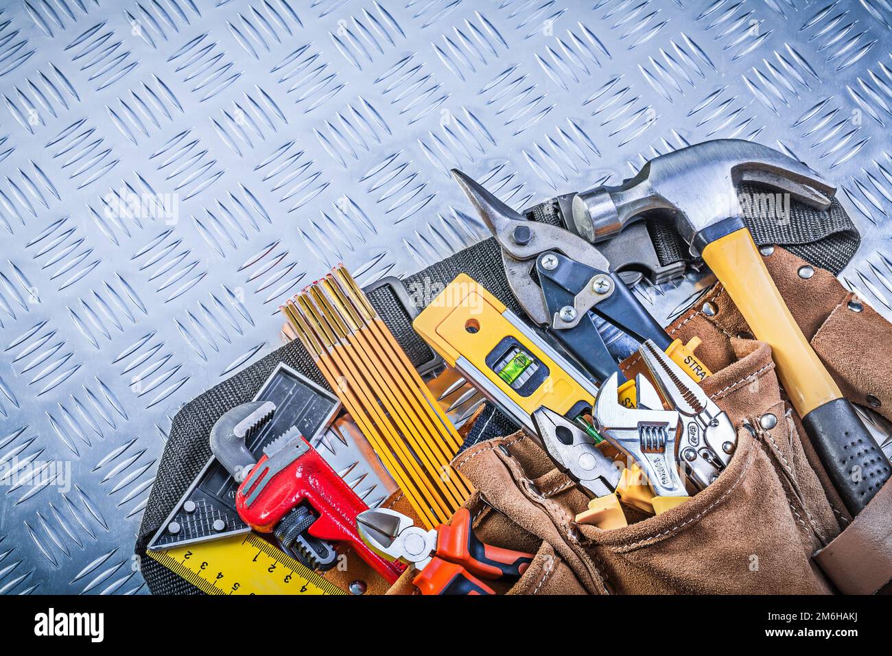 Tool belt with construction objects on corrugated metal pattern ...