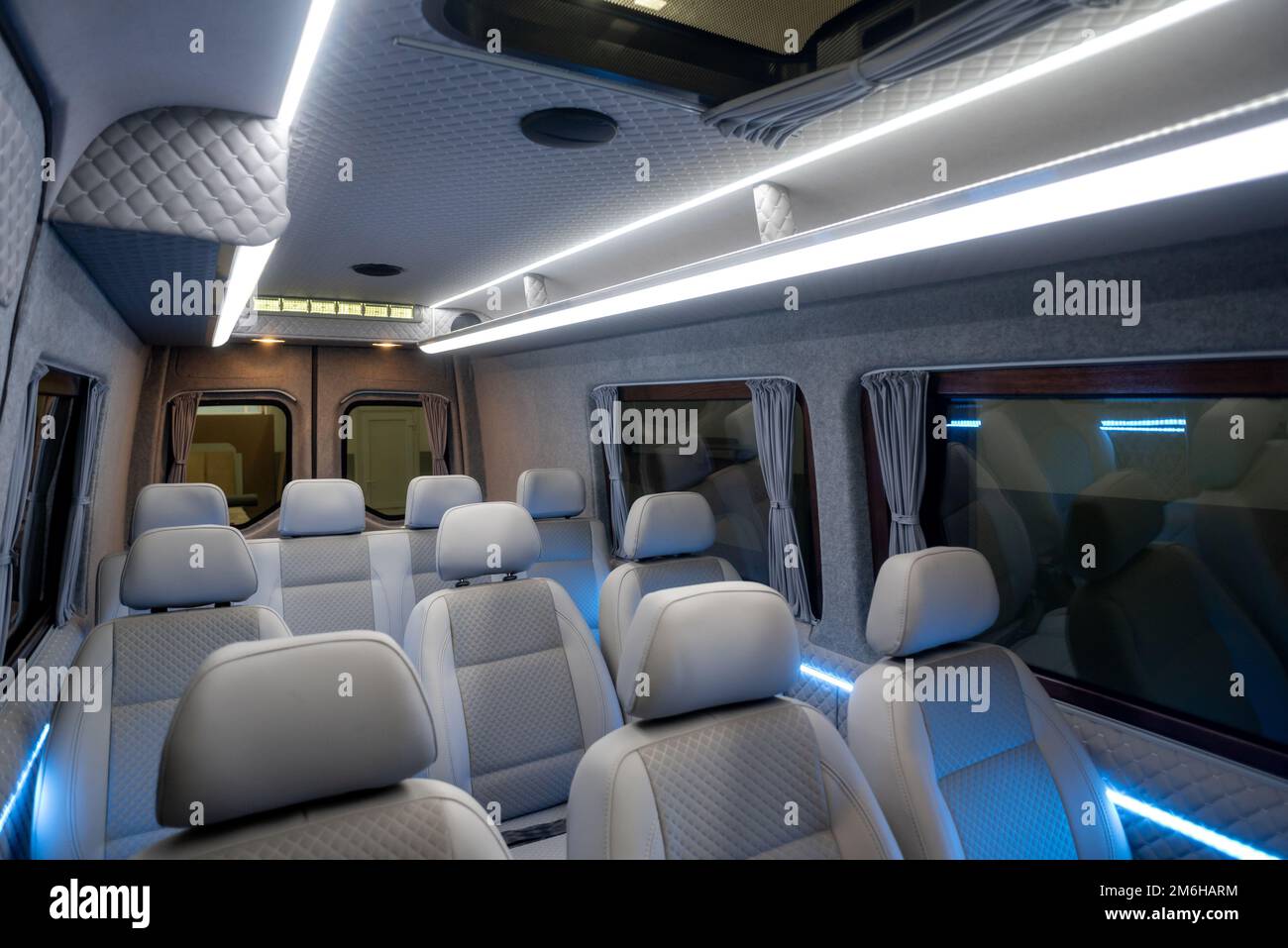 comfortable passenger bus interior with upholstered seats; individual ...