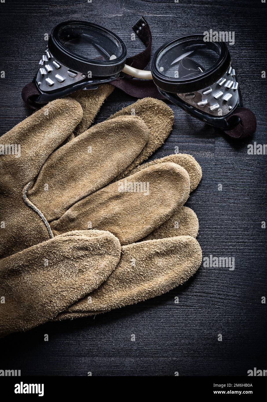 vertical view working goggles and protective gloves Stock Photo - Alamy