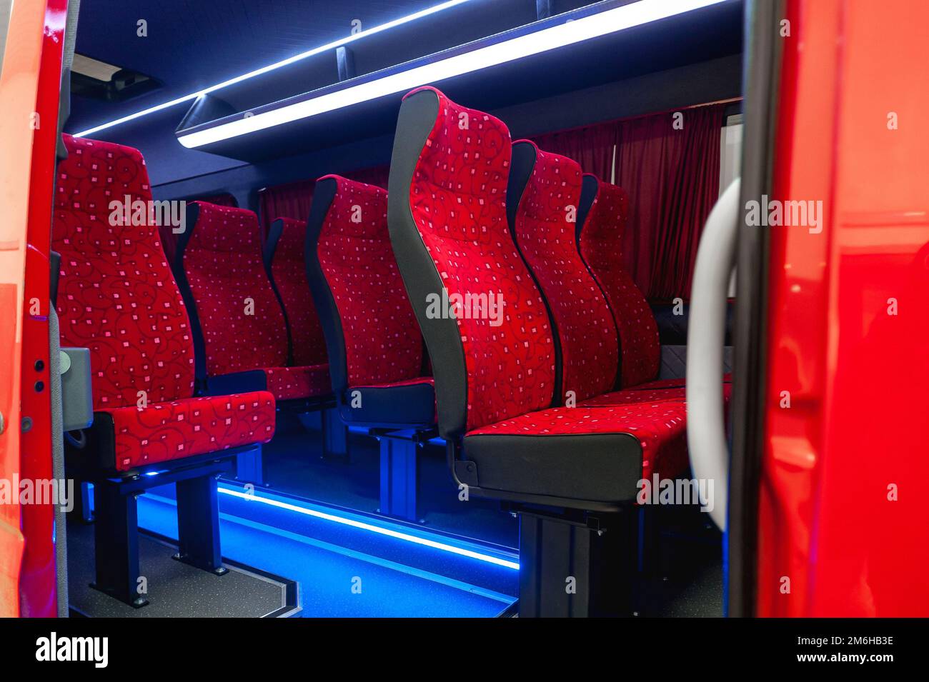 comfortable passenger bus interior with upholstered seats; individual ...