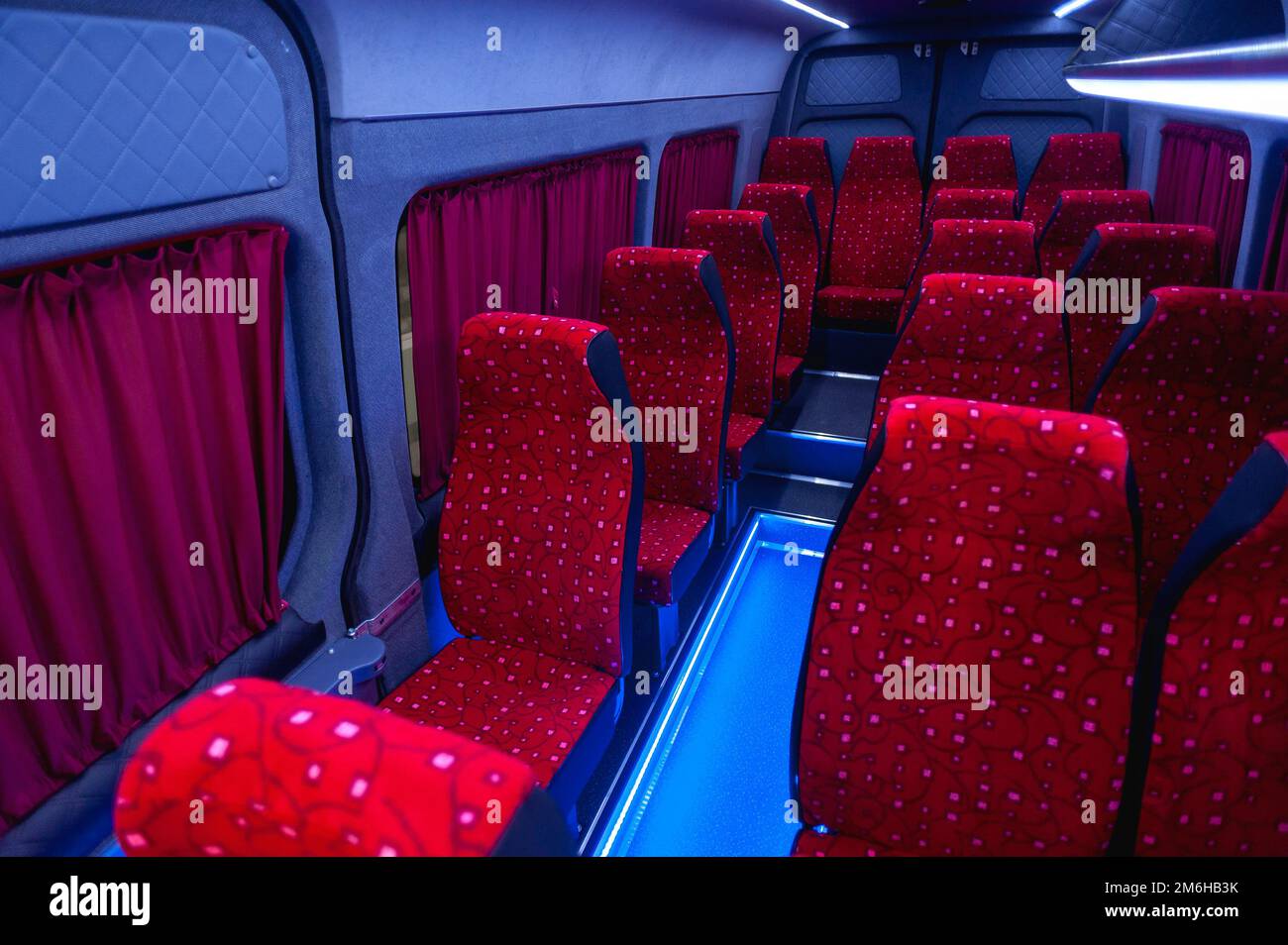 comfortable passenger bus interior with upholstered seats; individual ...