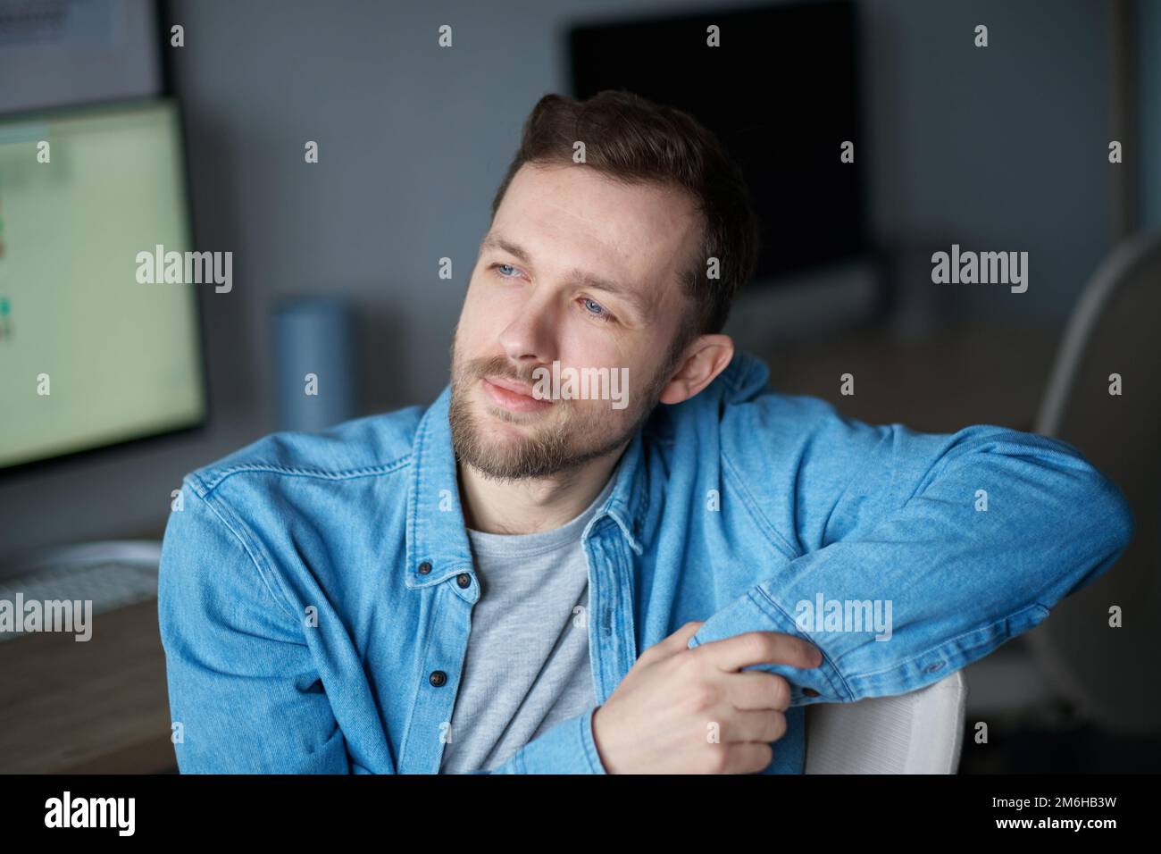 Positive emotion with computer monitor on background. Young handsome ...