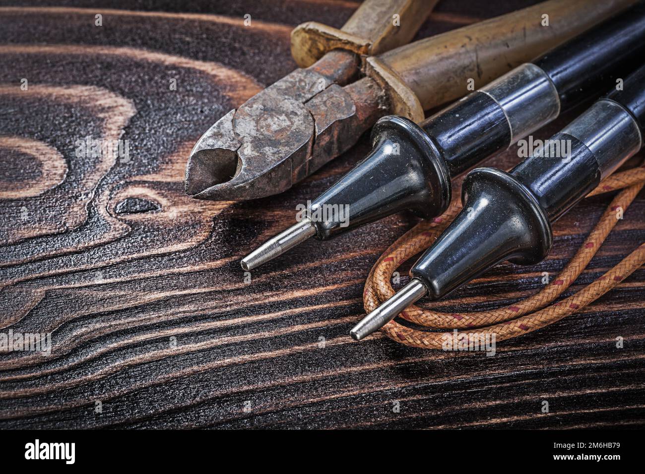 Vintage electric tester pliers on wooden board electricity concept ...