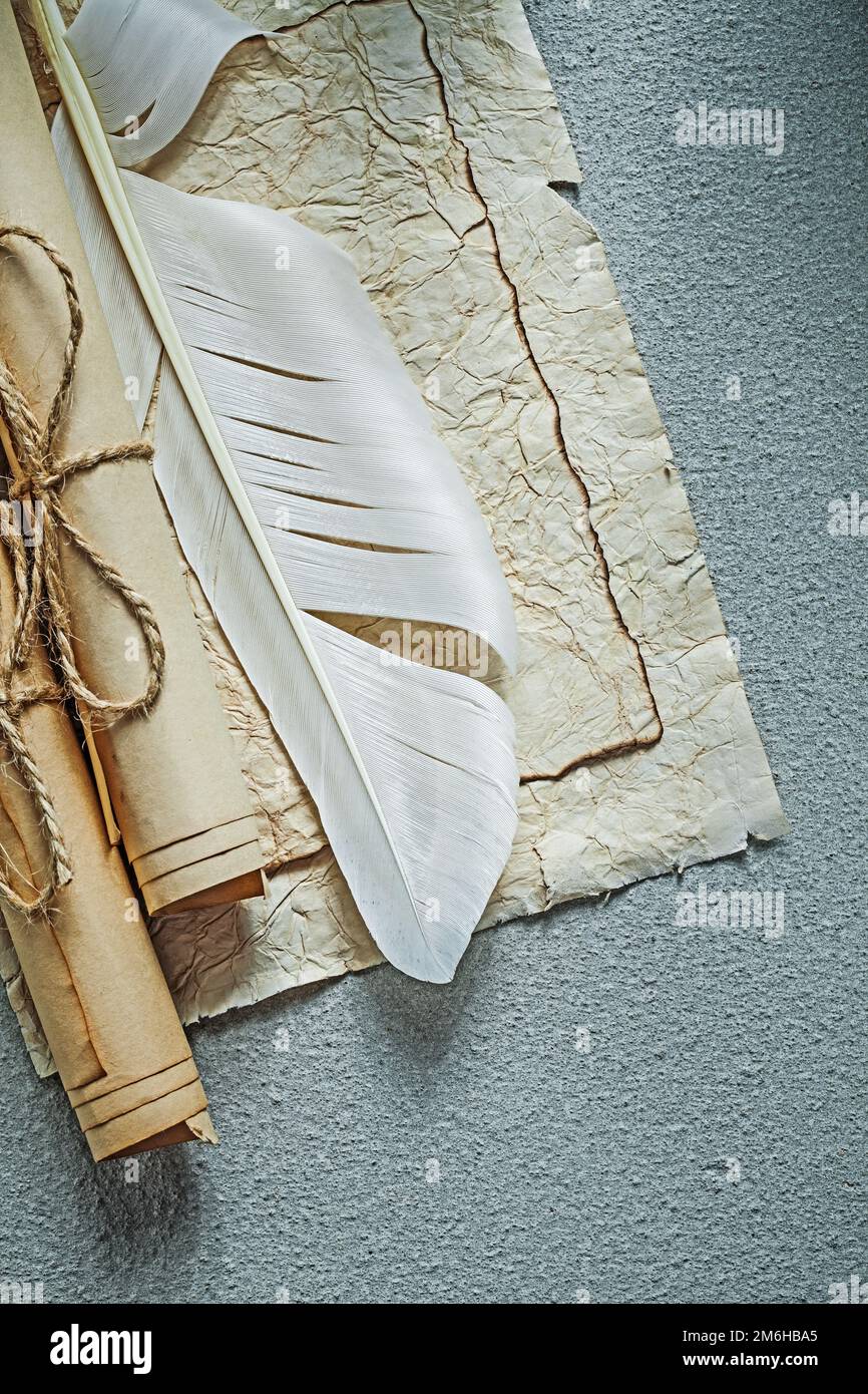 Vintage paper rolls quill on grey background Stock Photo - Alamy