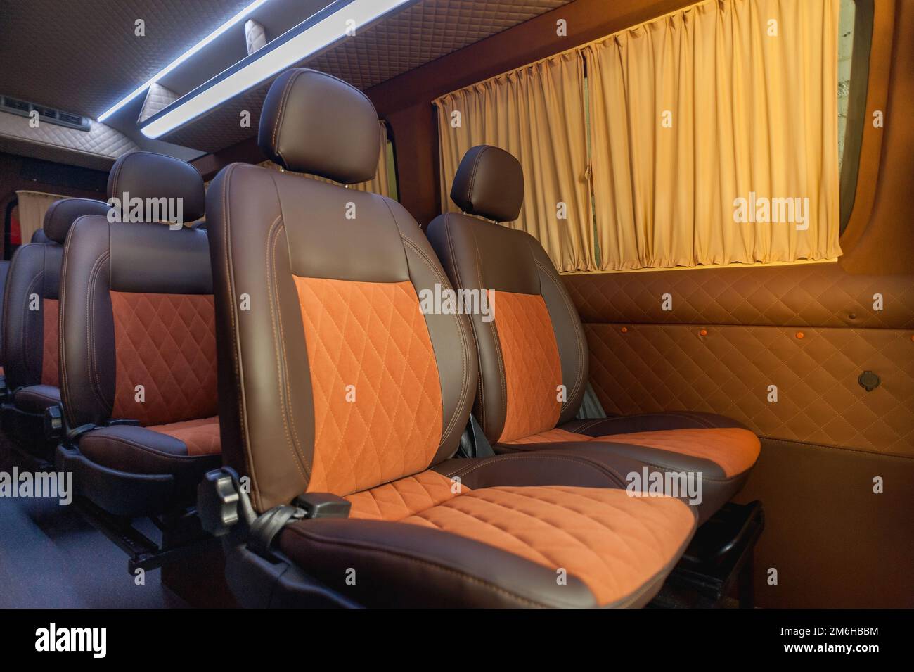 comfortable passenger bus interior with upholstered seats; individual ...