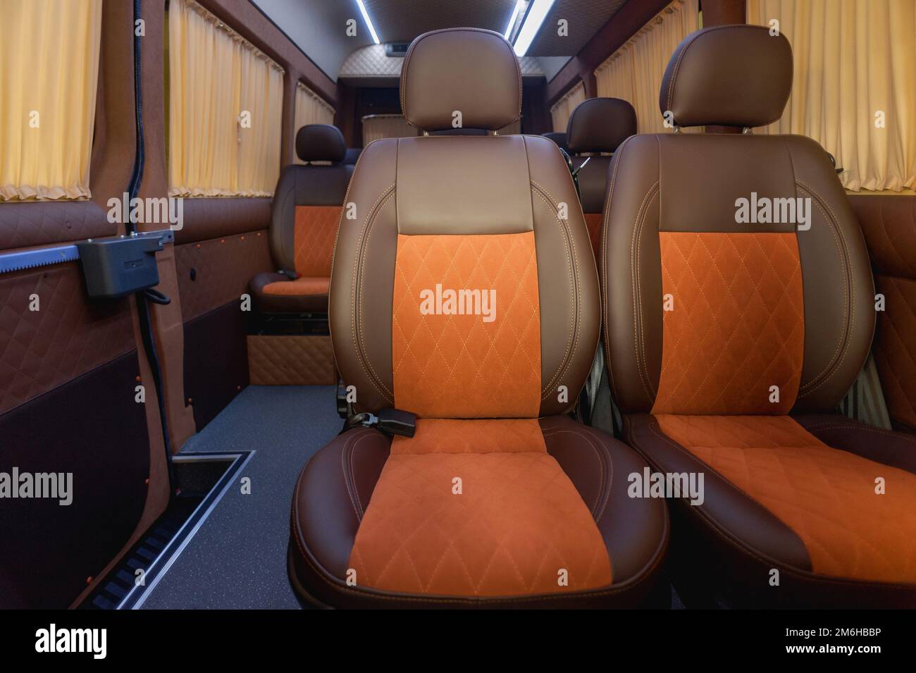 comfortable passenger bus interior with upholstered seats; individual ...
