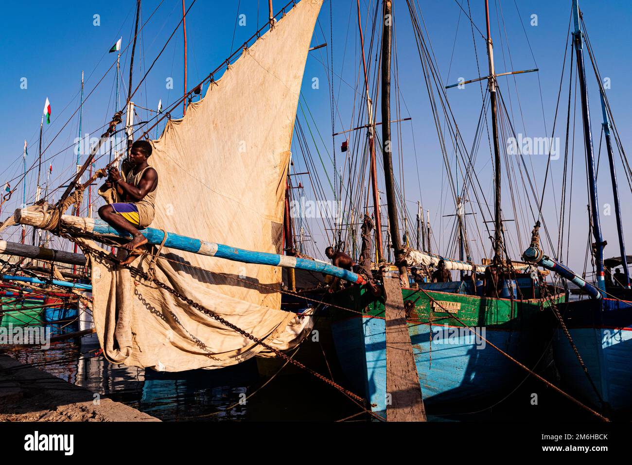 Man sitting on the yard of a fishing boat in the Arab quarter, yard ...