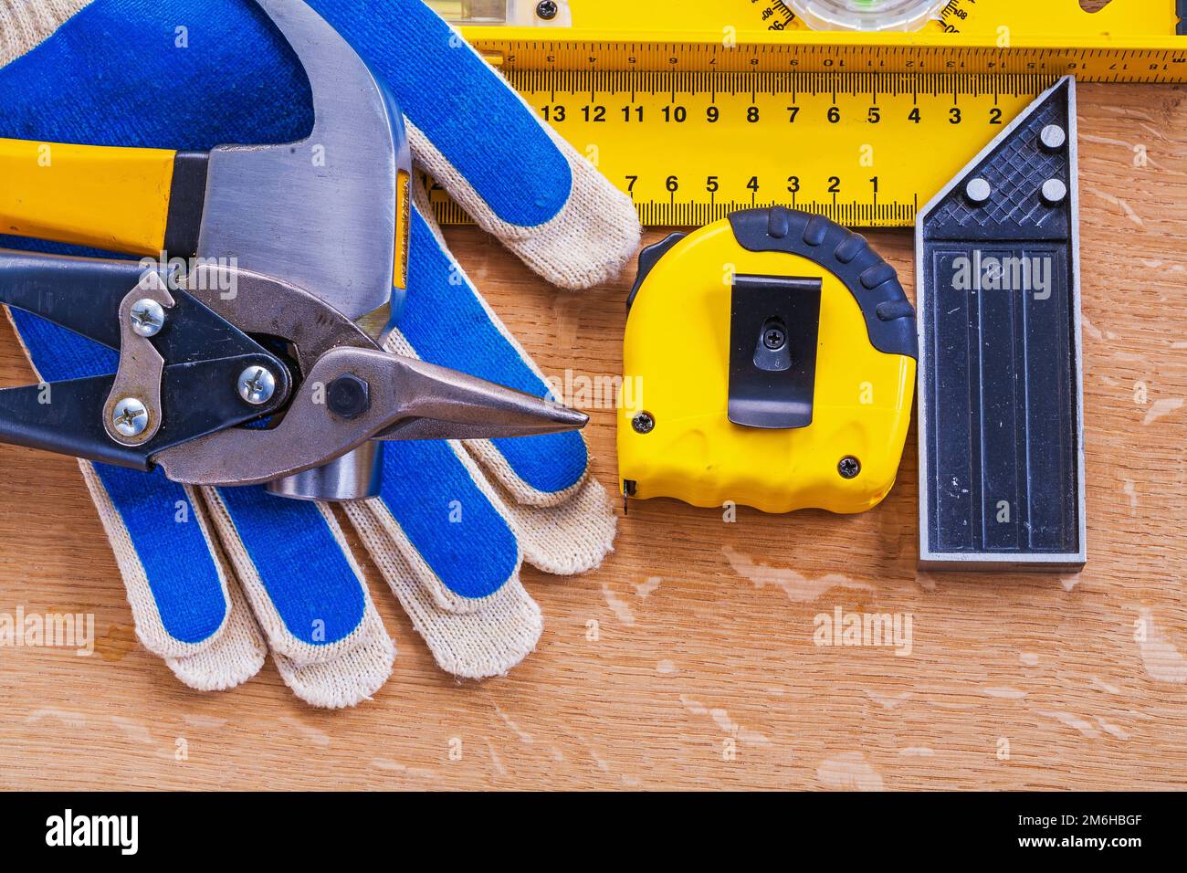 Vintage wood board with construction level protective gloves hammer ...