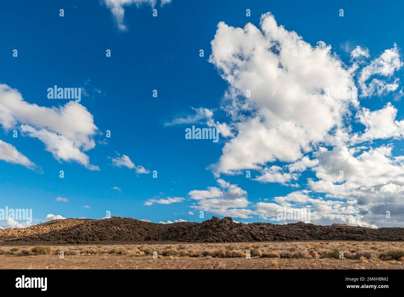 A landscape of Clouds over Desert Mountains in Nevada with blue sky on ...