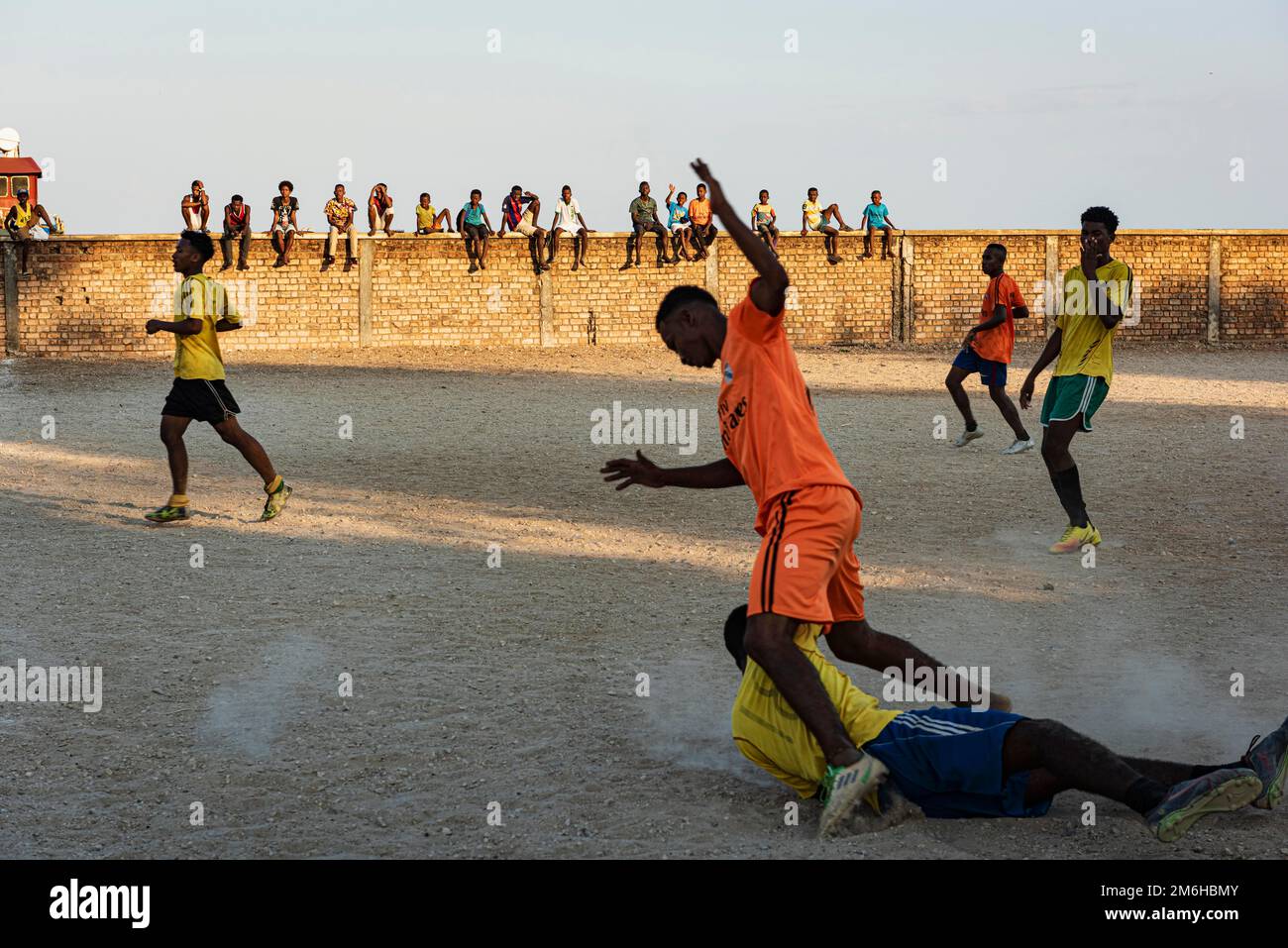 Boys, football pitch, youths playing football, wall with spectators ...