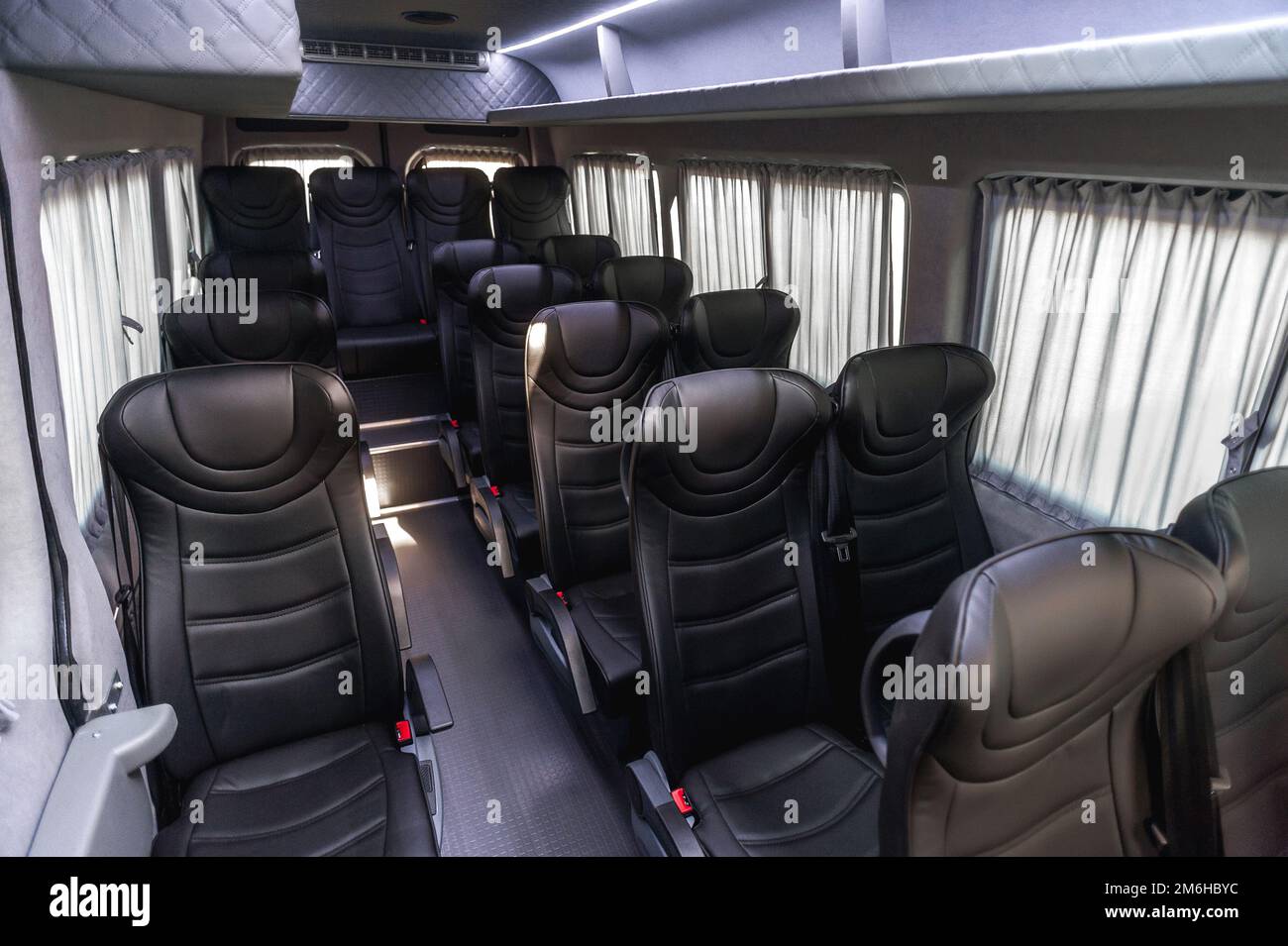 comfortable passenger bus interior with upholstered seats; individual ...