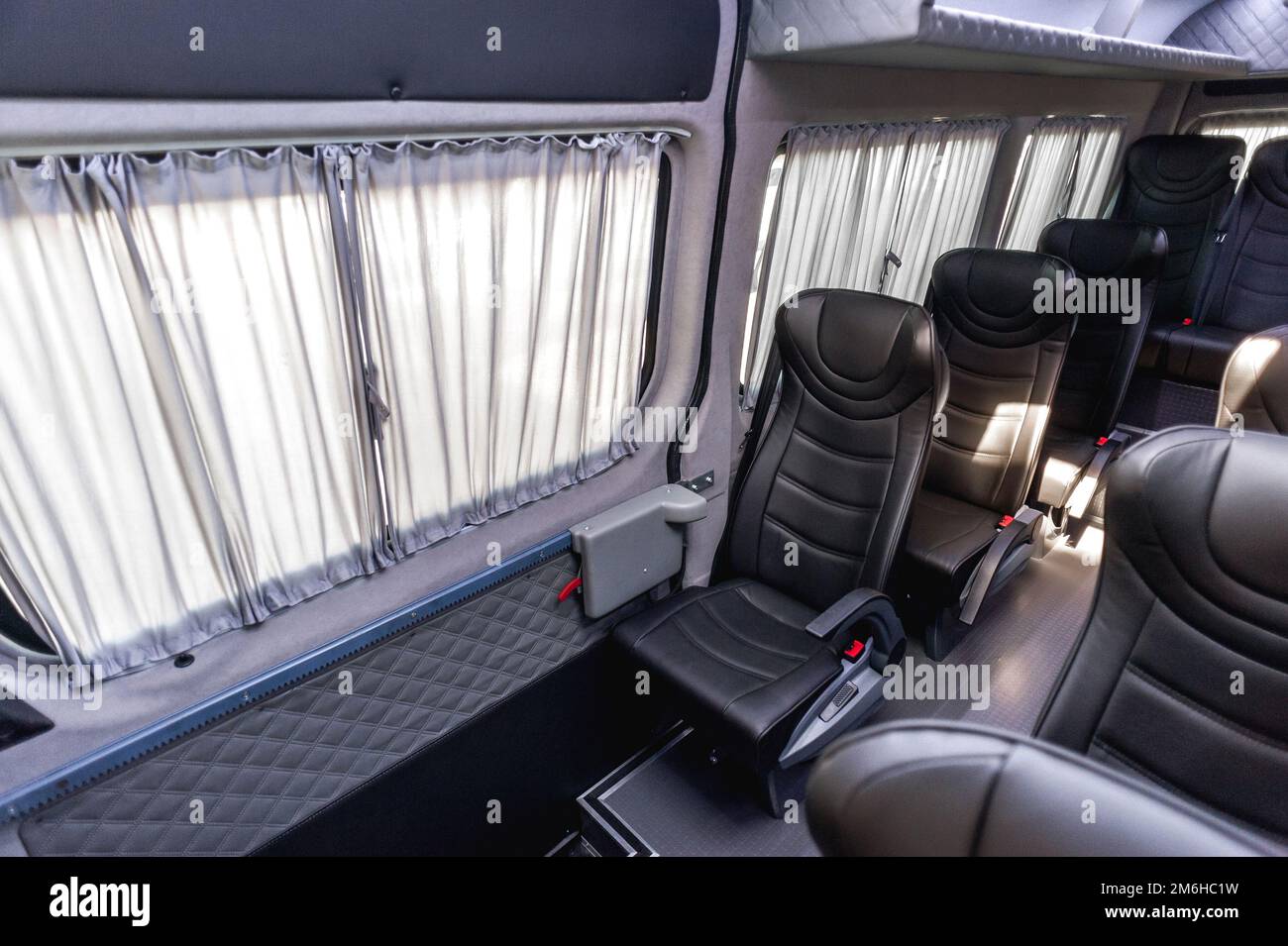 comfortable passenger bus interior with upholstered seats; individual ...
