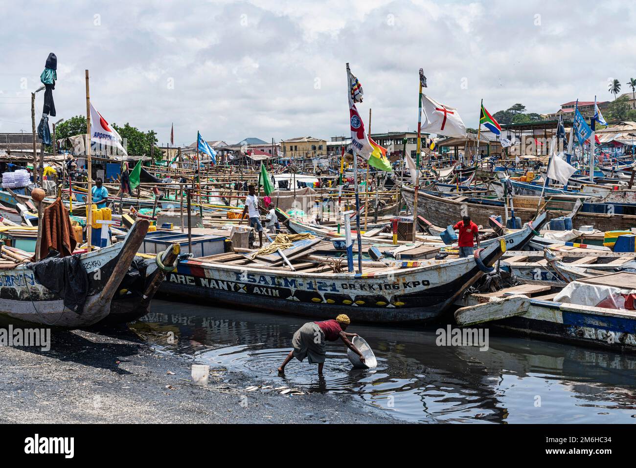 Colourful flags, traditional fishing boats, Elmina fishing port, Gold ...