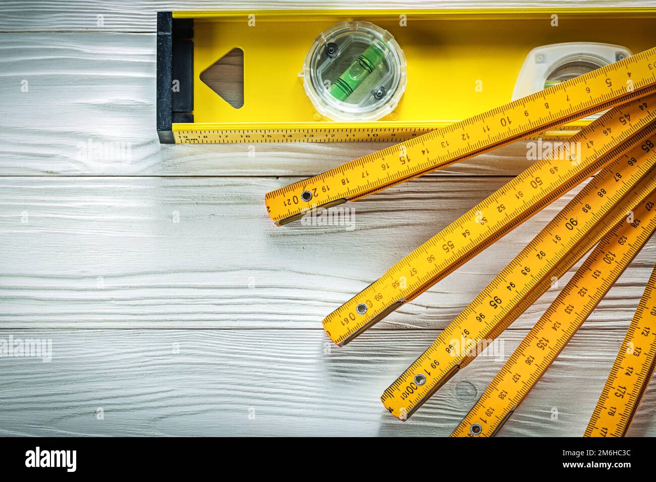Wooden meter construction level on white board top view Stock Photo - Alamy