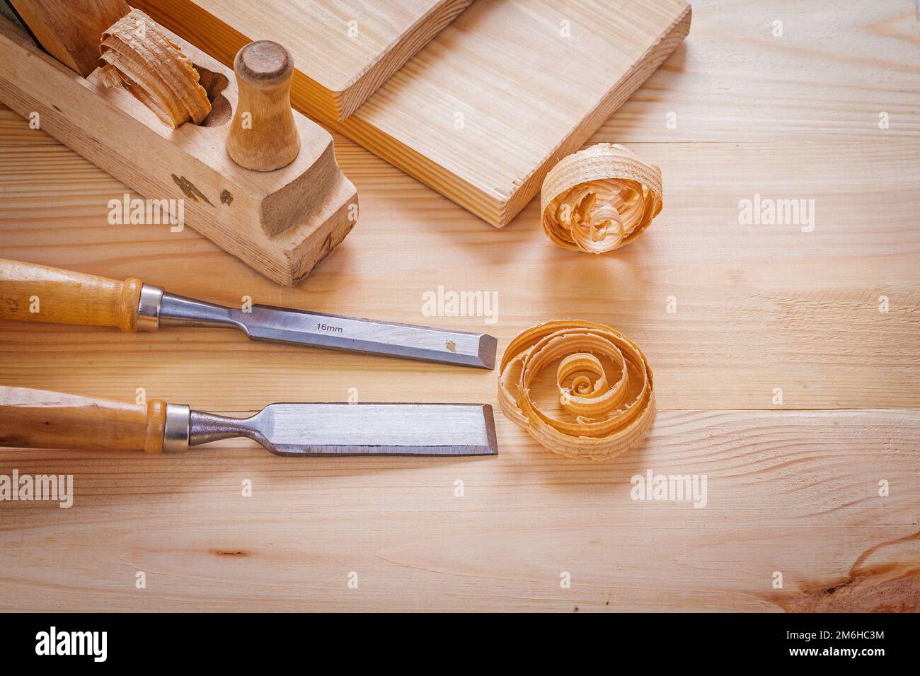 woodworkers plane and carpentry chisels on wooden boards horizontal ...