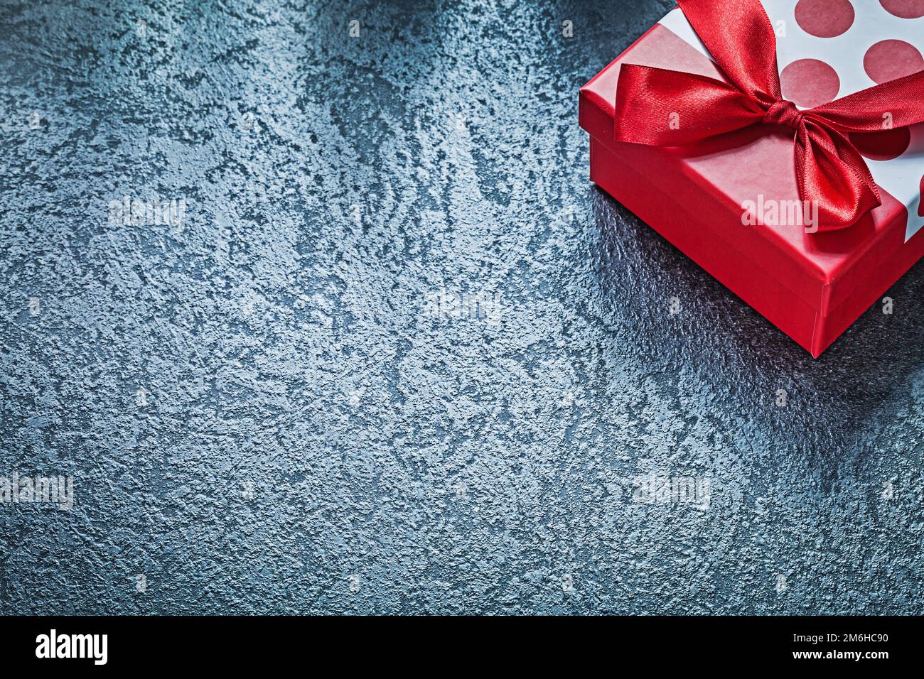 Wrapped present box with tied bow on black background celebrations ...