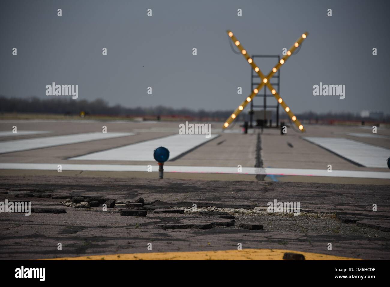 An illuminated X sign sits on a closed runway at Sioux Gateway Airport ...
