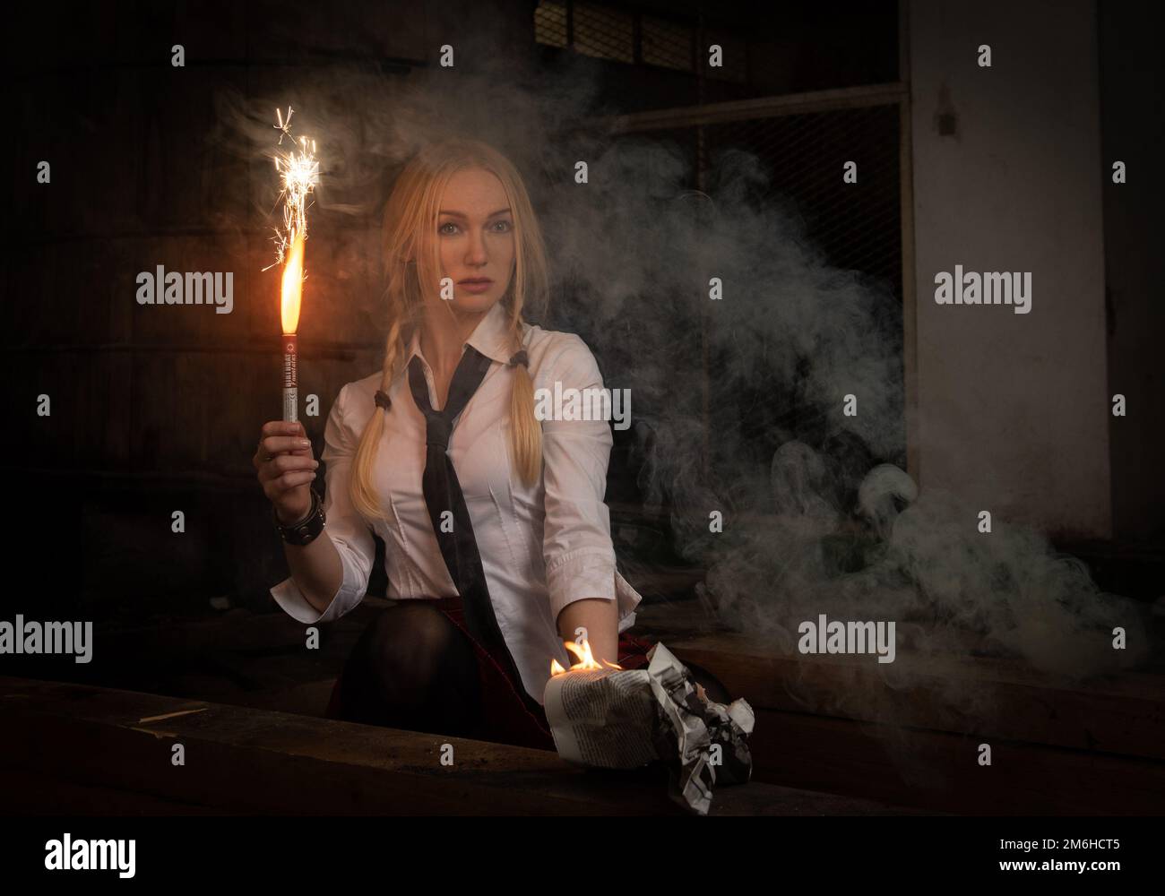 Woman holding burning fire stick. Fire smoke and flames Stock Photo - Alamy