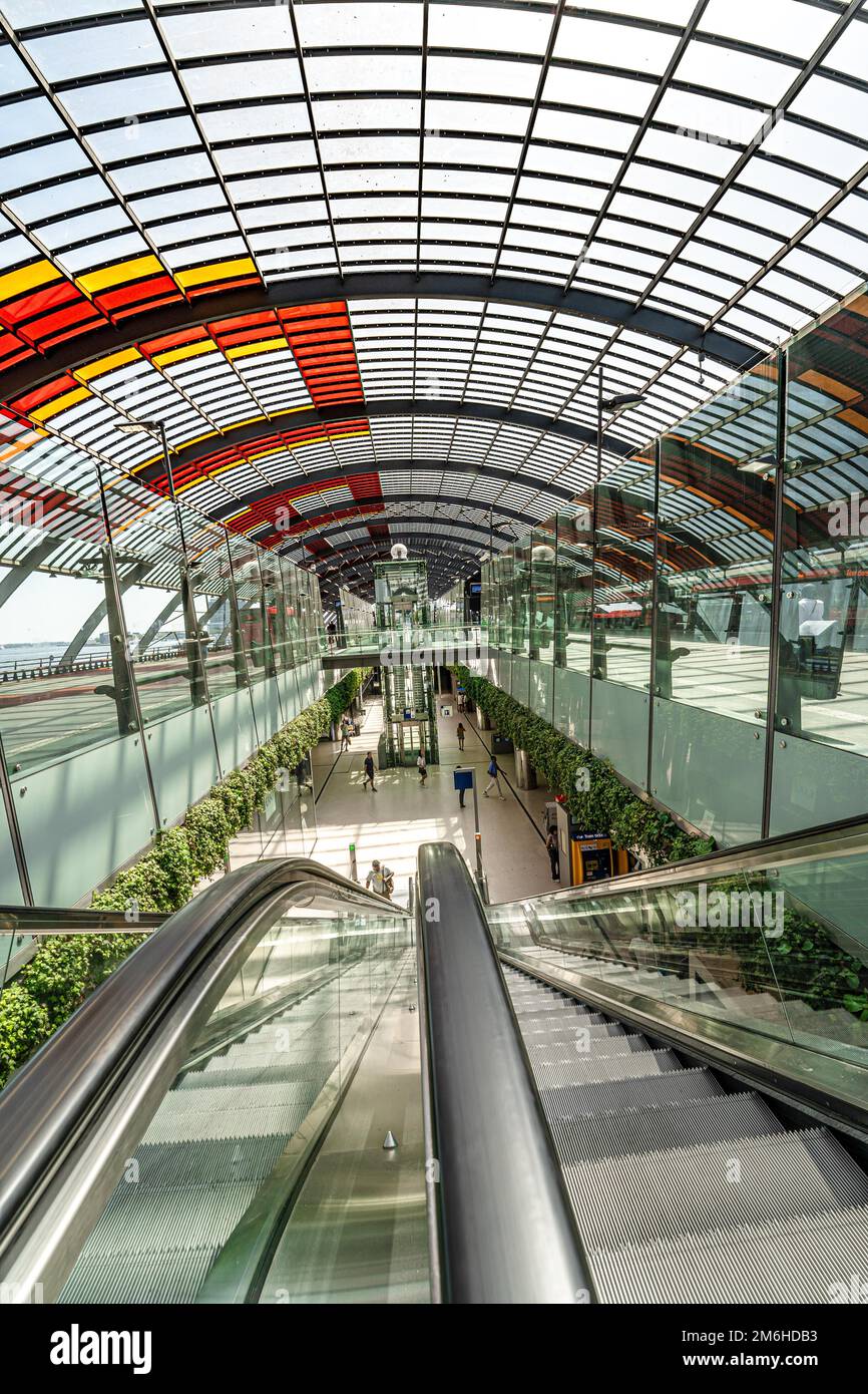 Escalators at a futuristic bus station with glass roof, Amsterdam ...