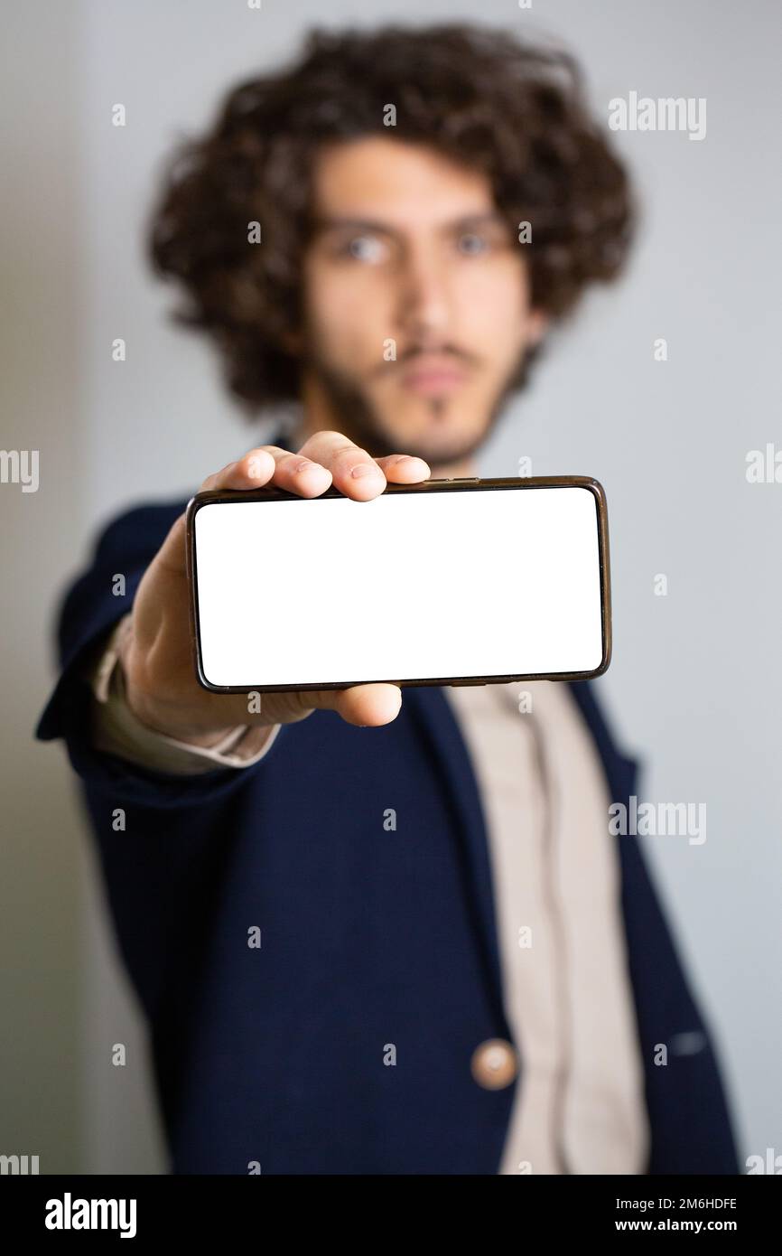Boy showing smartphone with white screen, selective focus on mobile ... Boy showing smartphone with white screen, selective focus on mobile ...