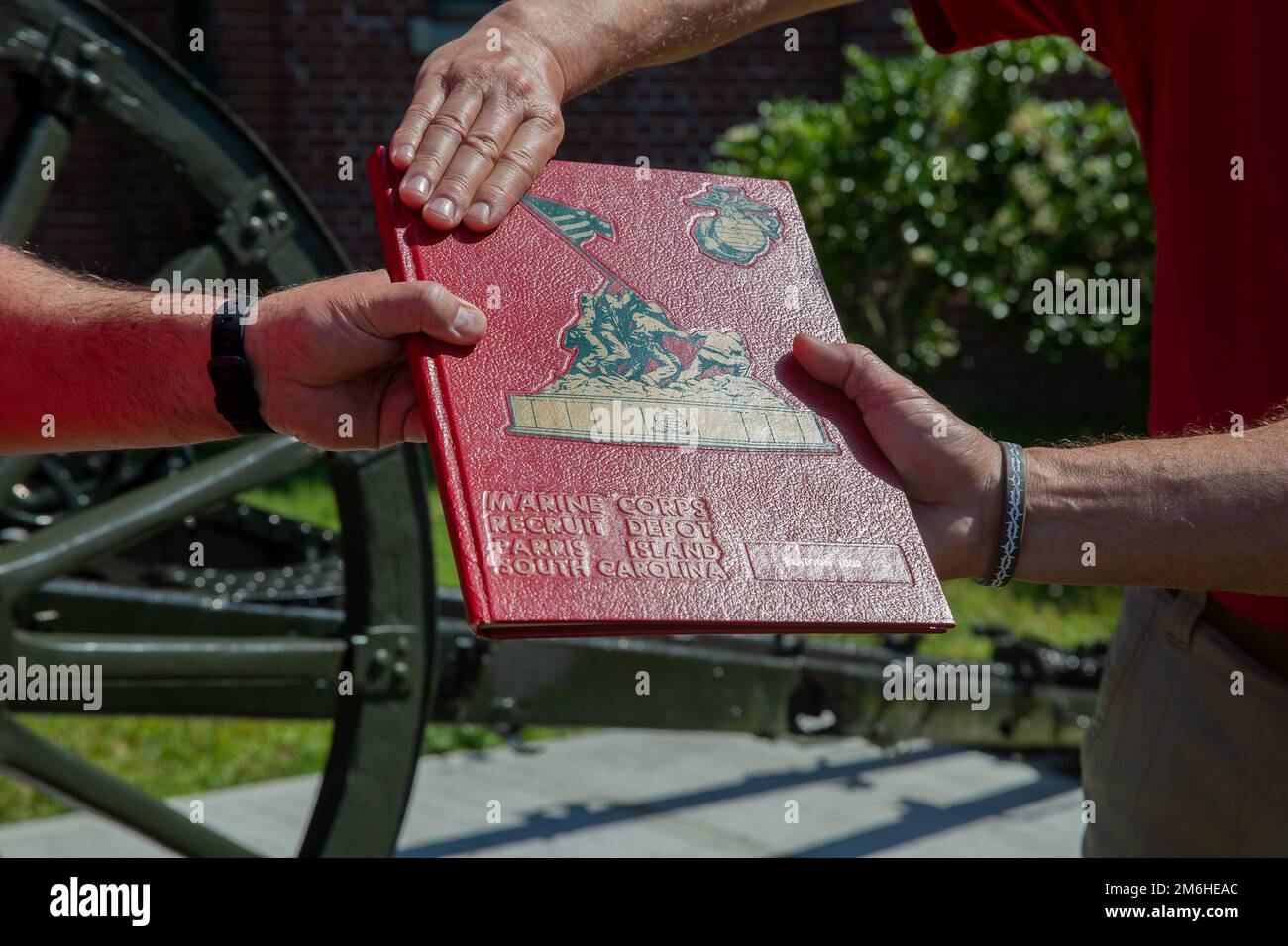 U.S. Marine Corps veterans hold their graduation photo album for ...