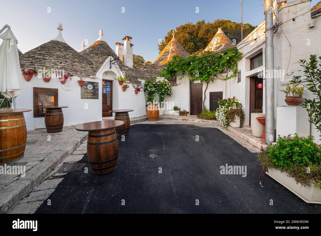 Wine barrels in front of trulli with flowers, Alberobello, Italy Stock ...