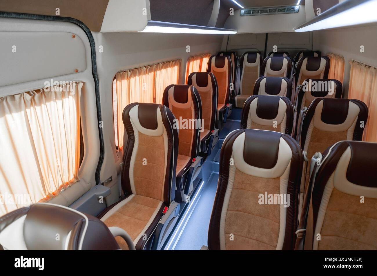 comfortable passenger bus interior with upholstered seats; individual ...