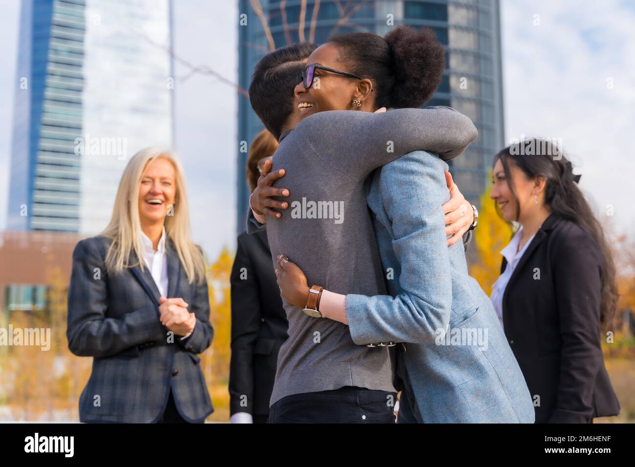 Middle-aged multi-ethnic businessmen and businesswomen giving each ...